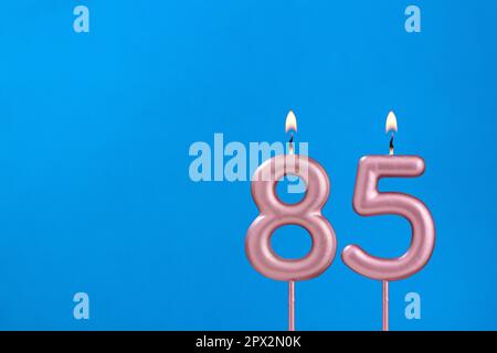 Number 85 - Silver Anniversary candle on orange background Stock Photo ...
