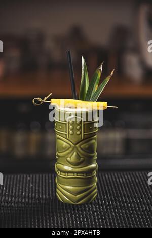 Pina colada cocktail in clay glass decorated with piece and leaf of ...