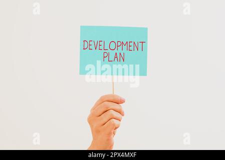 Sign displaying Development Plan, Business idea the planning of the ...