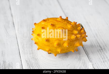 African horned cucumber on the wooden table Stock Photo - Alamy