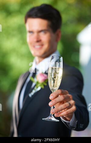 Heres to the happy couple. a young groom toasting his bride with ...