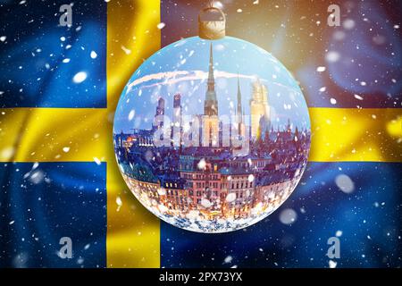 Swedish flag evening snow view through glass christmas ball, xmas time ...