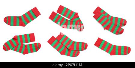 Set with pairs of striped socks on white background, top view. Banner ...