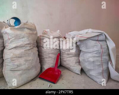 White polypropylene construction bags and scoop for garbage collection ...