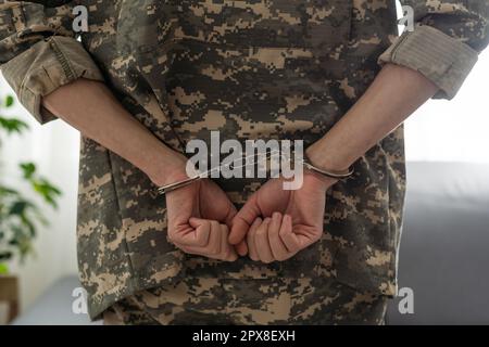 Handcuffed soldier, arrested male army officer in dark prison cell ...