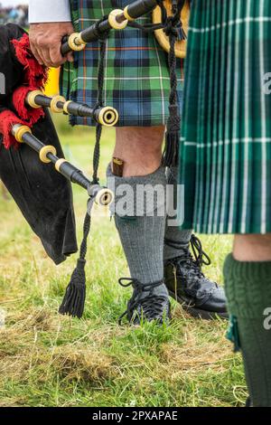 Scottish bagpipers dressed in traditional kilt during Highland Games ...