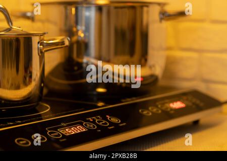 Metal Pot on induction hob in modern kitchen Stock Photo - Alamy