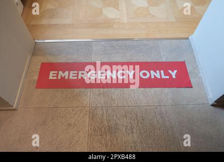 emergency only sign written on the floor Stock Photo - Alamy