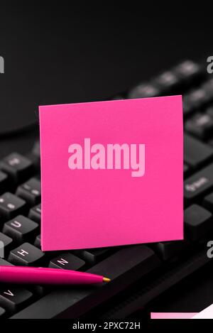 Colored sticker lying on black keyboard. Important information written ...