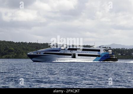 Fast ship sailing with hills in the background Stock Photo - Alamy