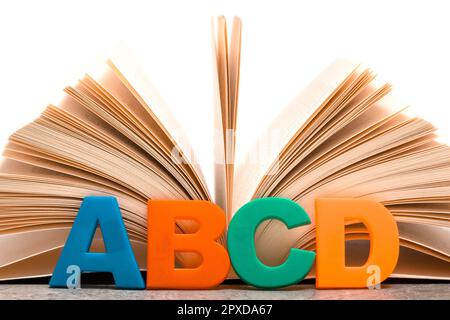 Alphabet letters ABCD and open book. Education concept Stock Photo - Alamy