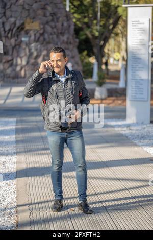 hispanic photographer taking photo on modern digital camera isolated on ...