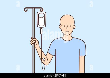 Bald young man with dropper with medication get chemo treatment in ...