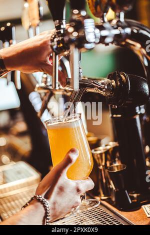 Cropped hand of bartender holding drink on bar counter Stock Photo - Alamy