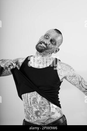 A young tattooed male posing against a white background Stock Photo - Alamy