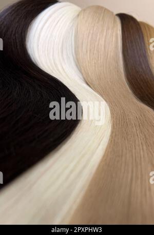 Strands of natural hair in different colors for extensions with tools ...