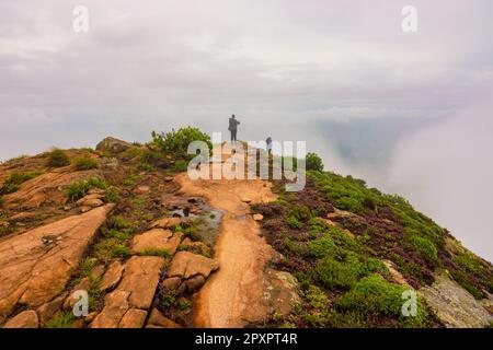 Rear view of hikers at Mount Longido an a rainy day in rural Tanzania ...