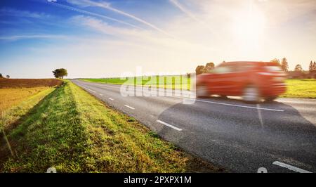 Car moving on the coutry road in sunset Stock Photo - Alamy