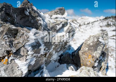 Ice covered rocks showing the wind direction blowing in the mountain ...