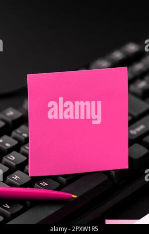 Colored sticker lying on black keyboard. Important information written ...