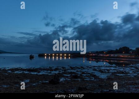 Peaceful, calm, serene Kenmare bay with pier at twilight or night with ...