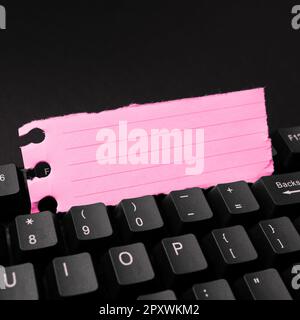Sticker lying on black keyboard. Important message written over paper ...