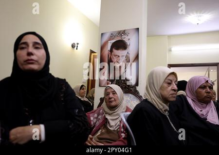 People give solace to Randa Musa (not seen), the wife of Khader Adnan ...