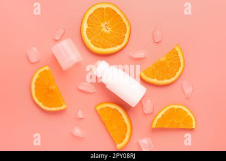 Open deodorant with orange slices and ice on color background Stock ...