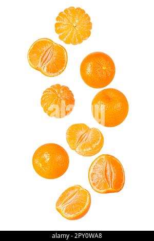 Isolated flying grapes. Nine whole and sliced mandarin fruits falling ...