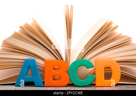 Alphabet letters ABCD and open book Stock Photo - Alamy