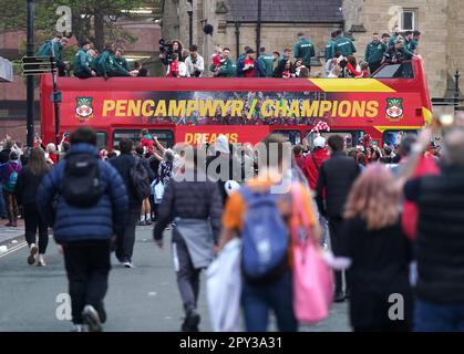 Wrexham players celebrate on an open-top bus during a victory parade in ...