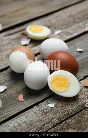 Hard boiled eggs and pieces of shell on white background Stock Photo ...