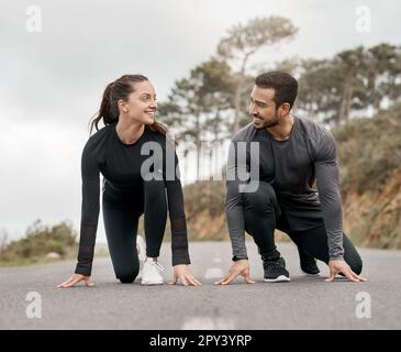 A young attractive man crouched in a park Stock Photo - Alamy