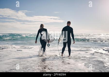 Young guy and woman pick out sports gloves in the store of sports ...
