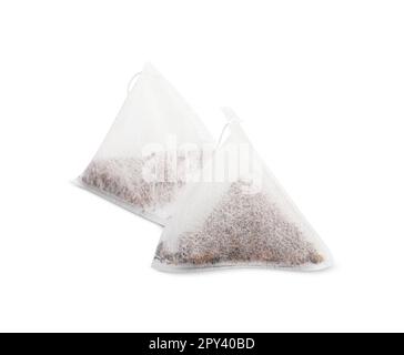 New pyramid tea bags on white background Stock Photo - Alamy