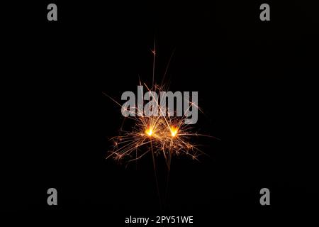 Two burning sparkler sticks glowing in dark Stock Photo - Alamy