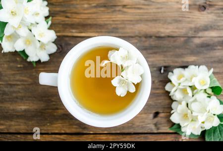 jasmine tea and jasmine flowers on wooden background Stock Photo - Alamy
