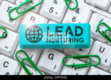 Hand writing sign Lead Nurturing, Business approach method of building ...