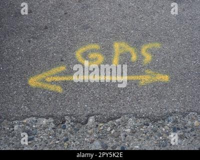 gas pipe arrow sign painted on tarmac Stock Photo - Alamy
