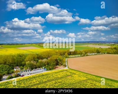 Aerial shot of beautiful cultivated landscape with rapeseed, wheat and ...