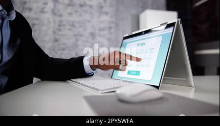 Businessperson Filling Online Survey Form On Digital Laptop Stock Photo ...