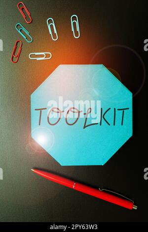 Sign displaying Toolkit, Word Written on set of tools kept in a bag or ...