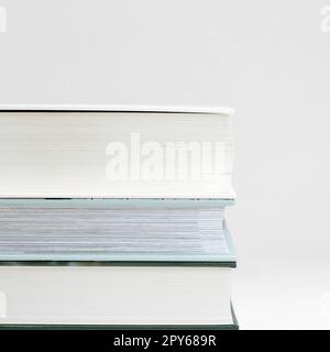 Three thick books with a white background Stock Photo - Alamy
