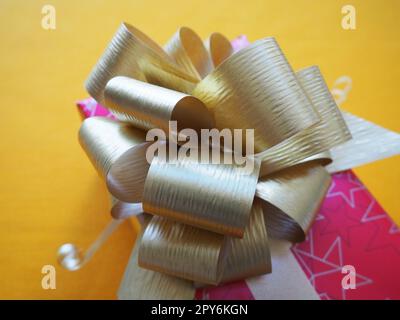 Golden ribbon with beautiful bow on white background Stock Photo - Alamy