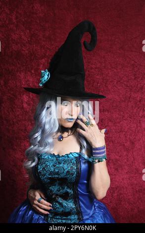 Halloween witch on dark blue background Stock Photo - Alamy