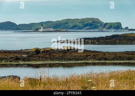 View of Fladda lighthouse from Luing island near Oban, Argyll, Scotland ...