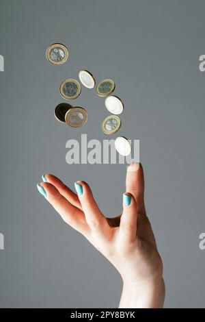 Female hand throwing cash coins into red piggy bank closeup Stock Photo ...