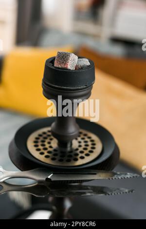 hookah bowl, shisha and coals close-up on smoky black background with ...