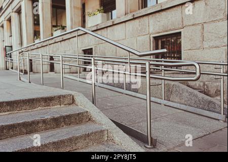 Tiled ramp with shiny metal railings outdoors Stock Photo - Alamy