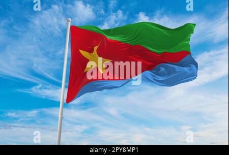 flag of Ethiopian Semitic peoples Tigrinyans at cloudy sky background ...